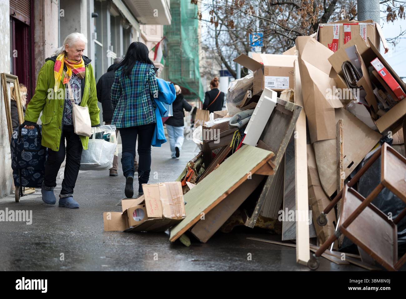 Lots of garbage on the street, people passing Stock Photo - Alamy