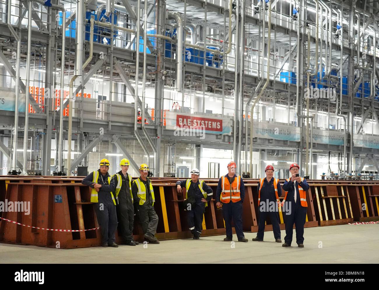 Workers look on during the official opening ceremony for the newly ...
