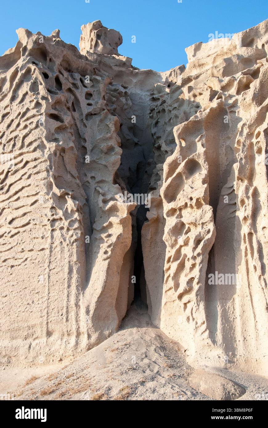 This image shows a volcanic cleft in Santorini, Greece. The cleft is a ...