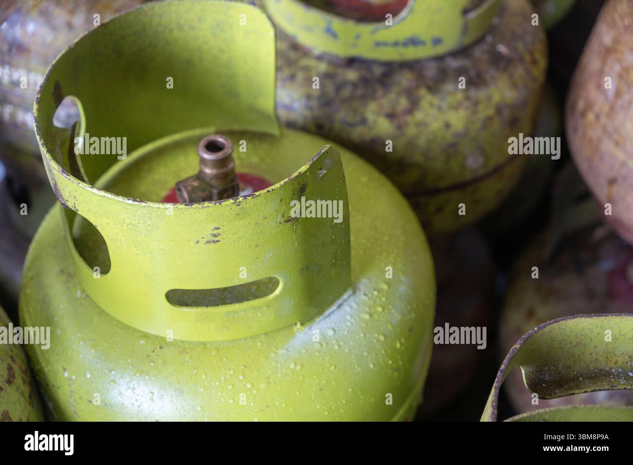 Stack of green gas tanks. The tanks are old and rusted Stock Photo - Alamy