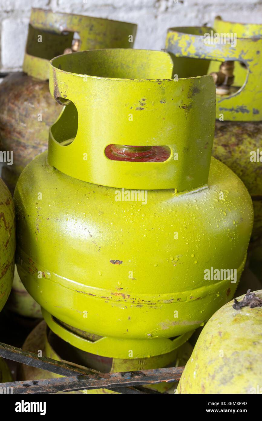 Stack of green gas tanks. The tanks are old and rusted Stock Photo - Alamy
