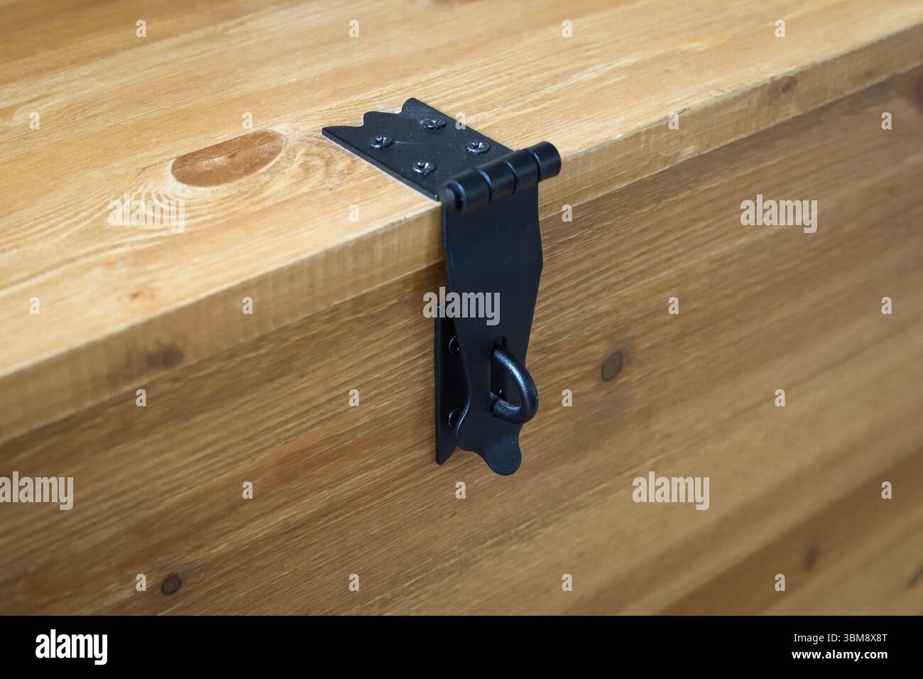 Black, iron lock on bright, wooden chest Stock Photo - Alamy