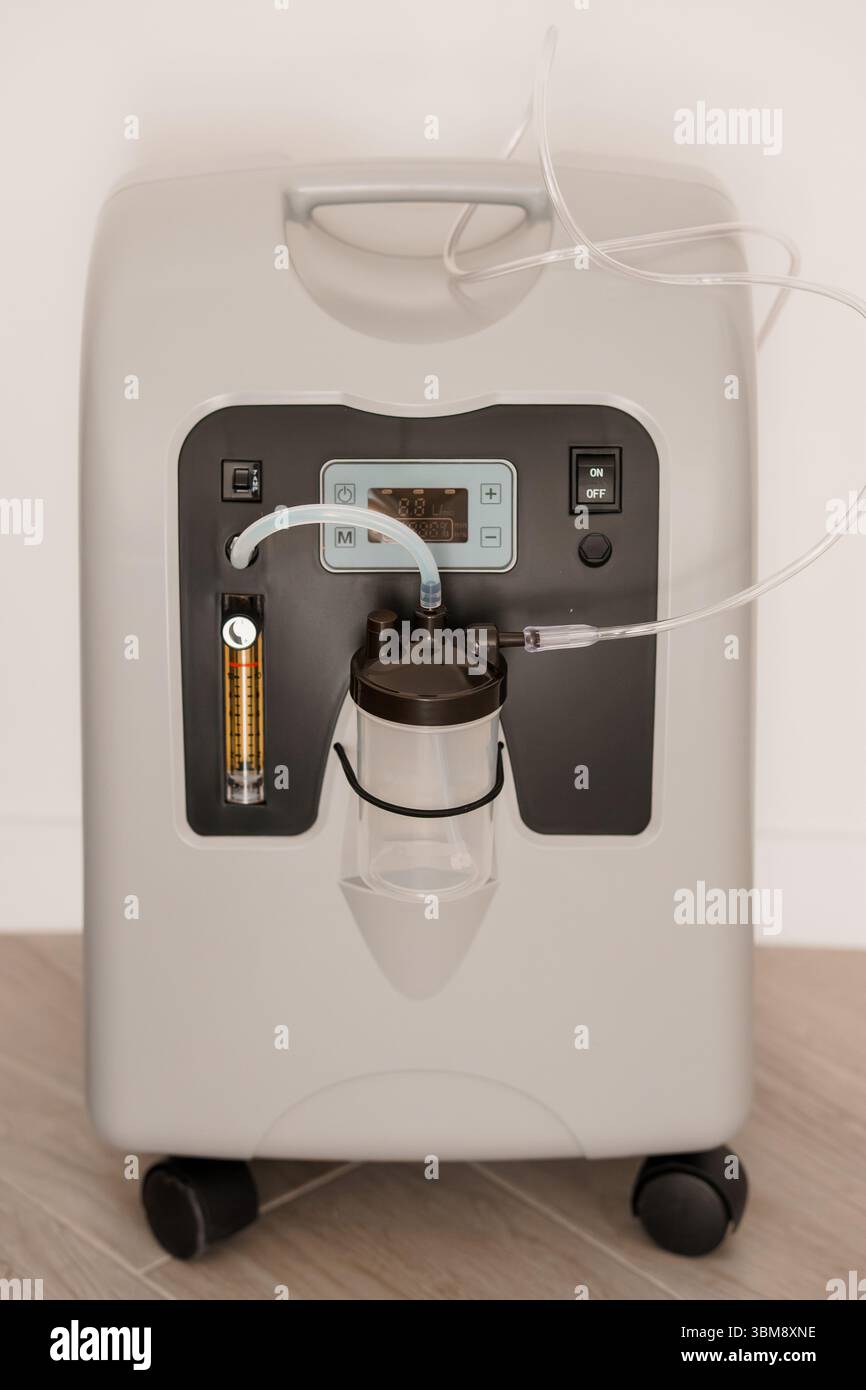A white portable oxygen concentrator sits indoors with its water ...