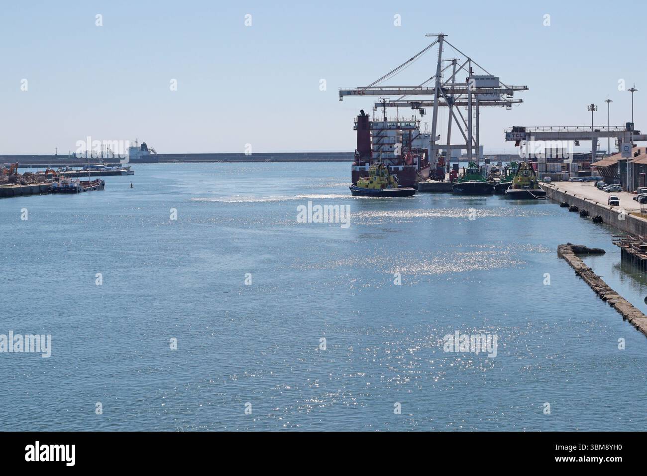 Industrial port scene in Porto, Portugal, featuring large cranes, cargo ...