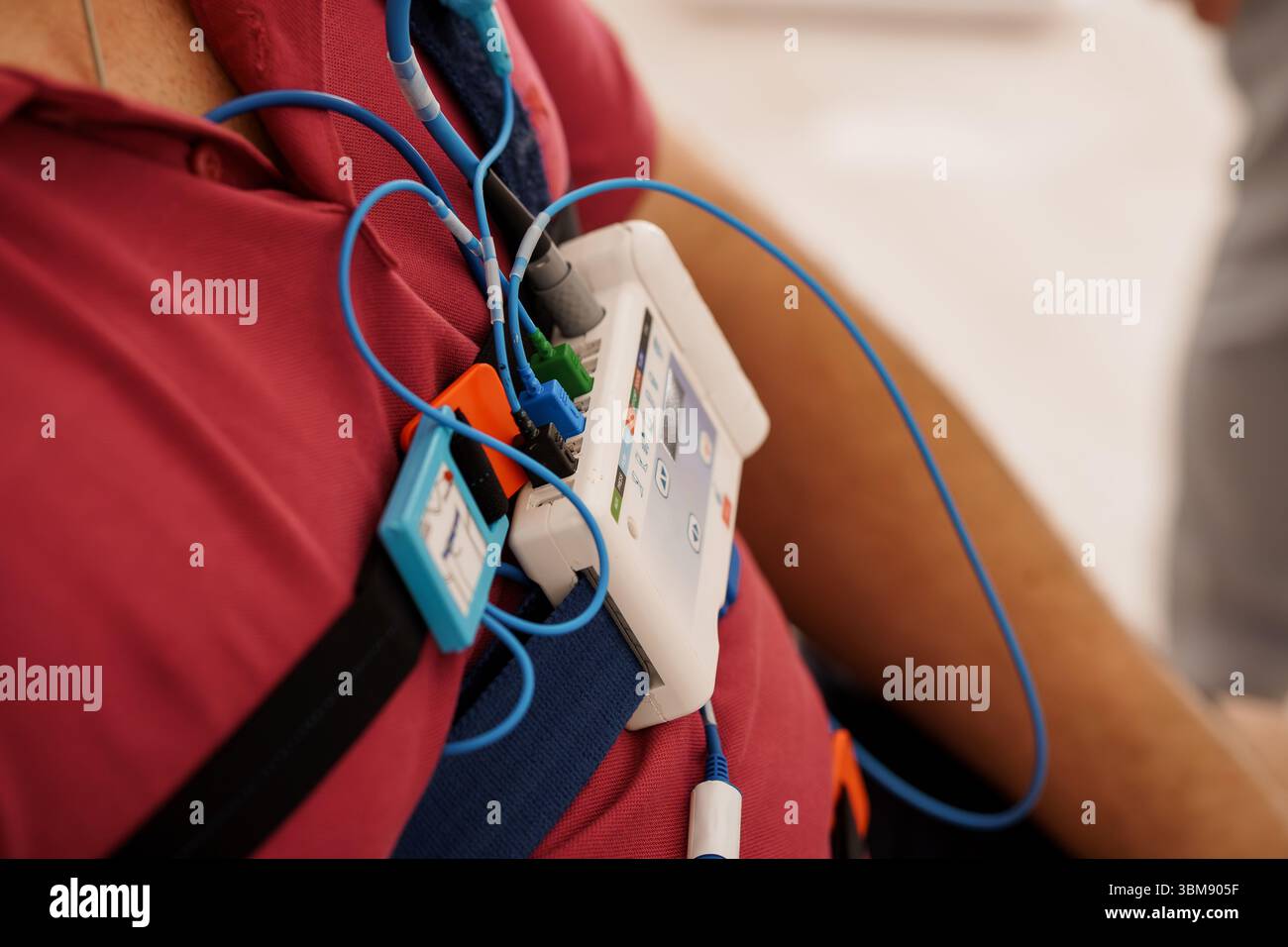 A detailed shot showcases a portable polysomnography device attached to ...