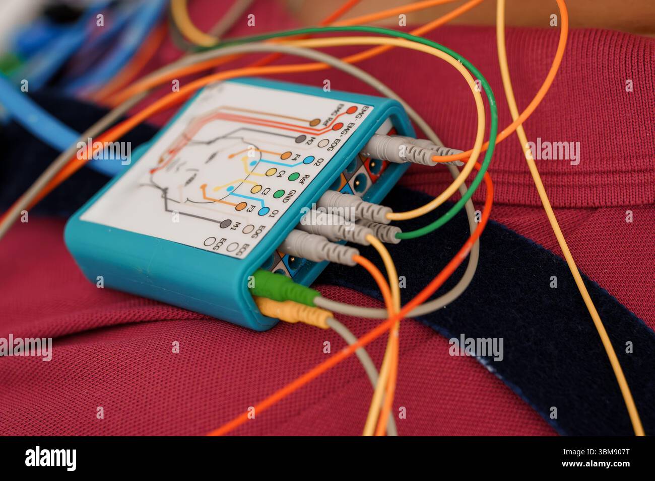 Polysomnography System Recording Setup with Multicolored Wires on Pink ...