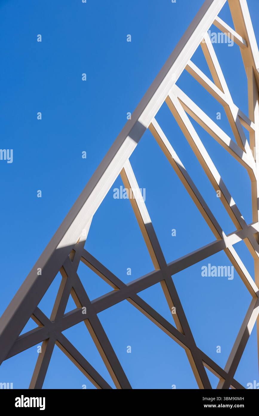 Abstract vertical photo. Metallic framework designed with geometric precision against a vibrant ...