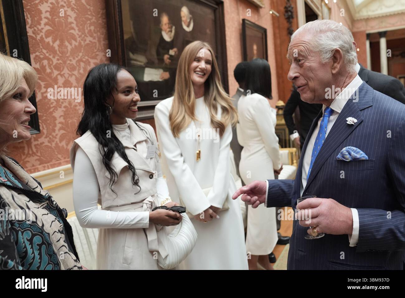 King Charles III speaks with Dame Joanna Lumley (left) and Rosie ...