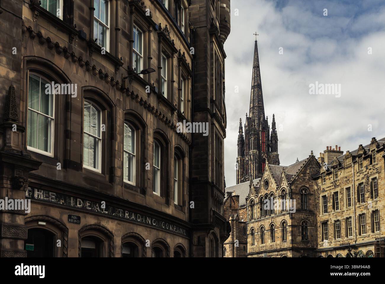 Edinburgh's historic street with a dramatic gothic spire amidst classic ...