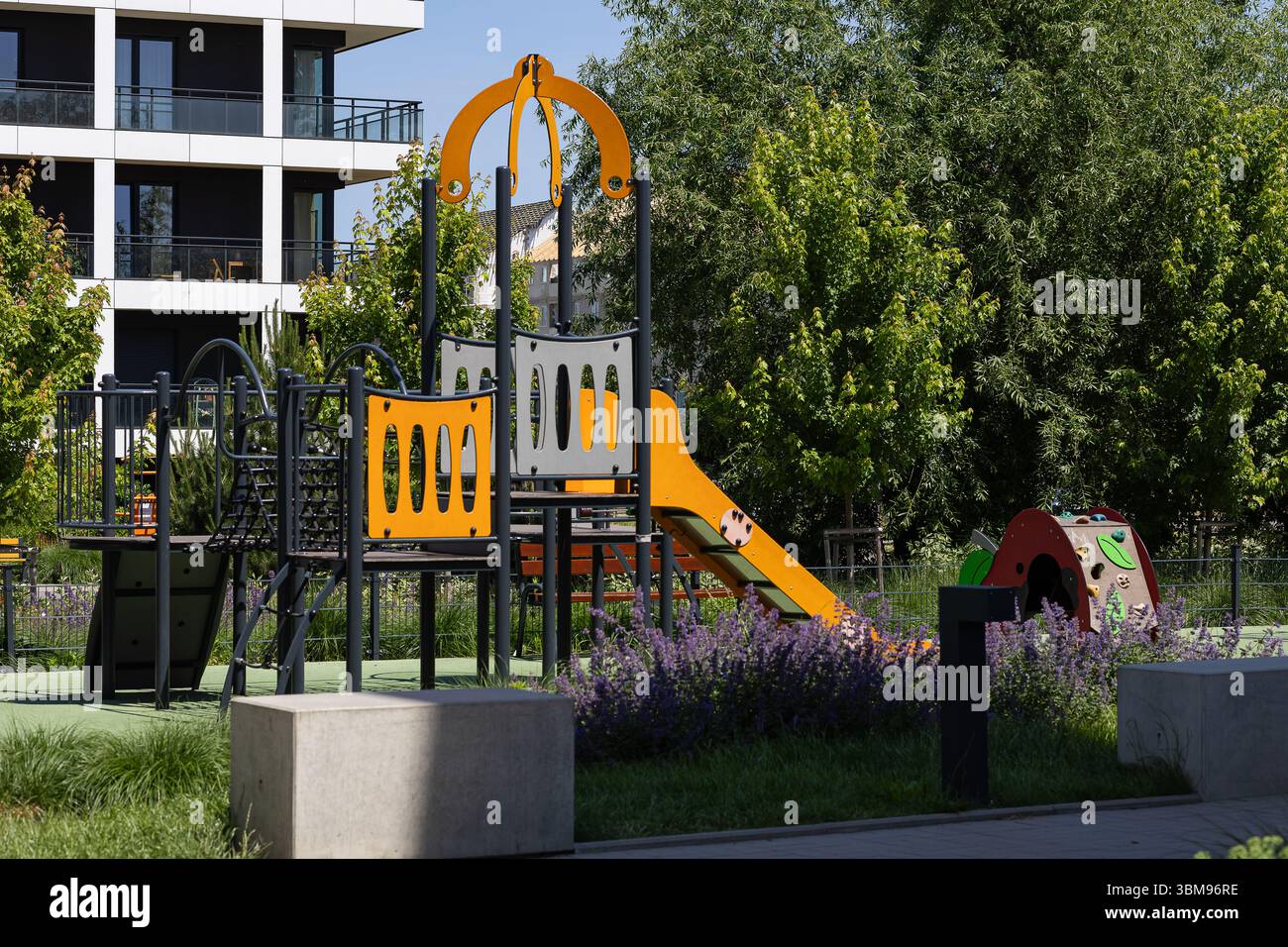 Modern children playground in residential area with colorful slide and ...