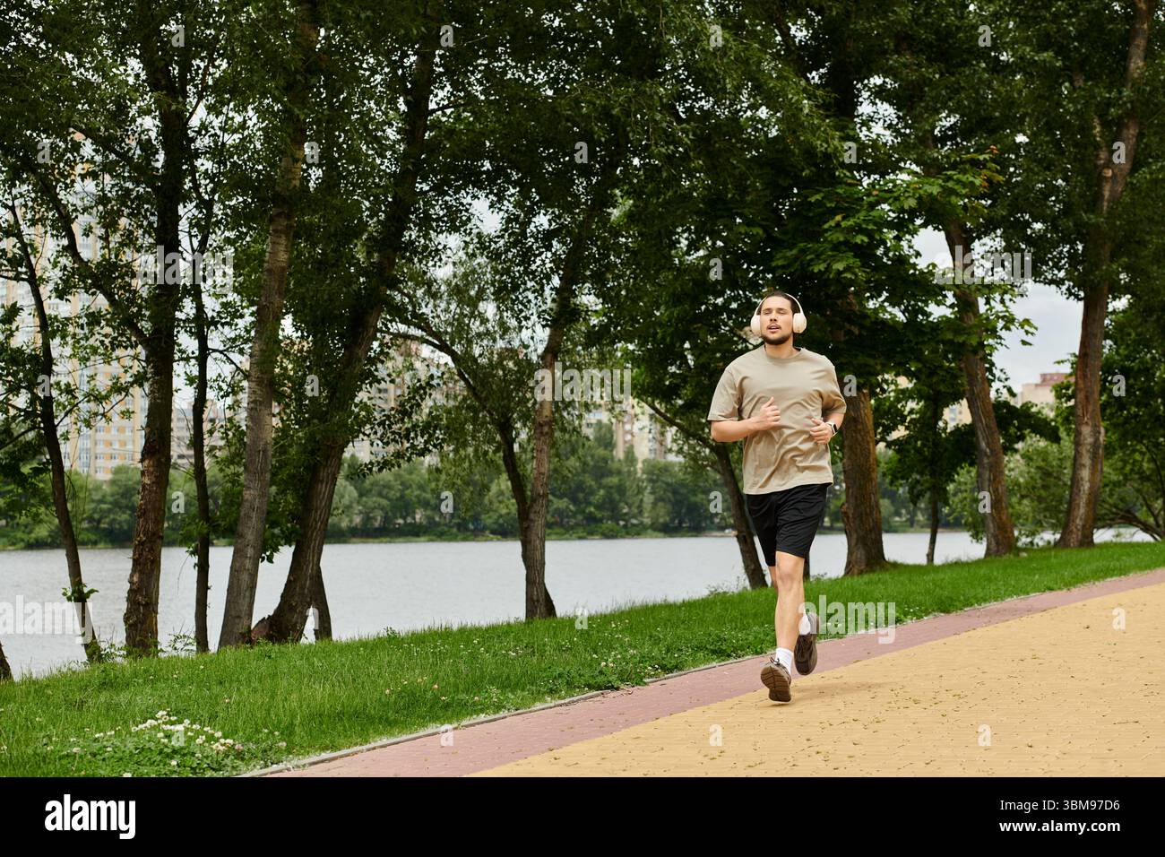 Young man jogs along park hi-res stock photography and images - Alamy