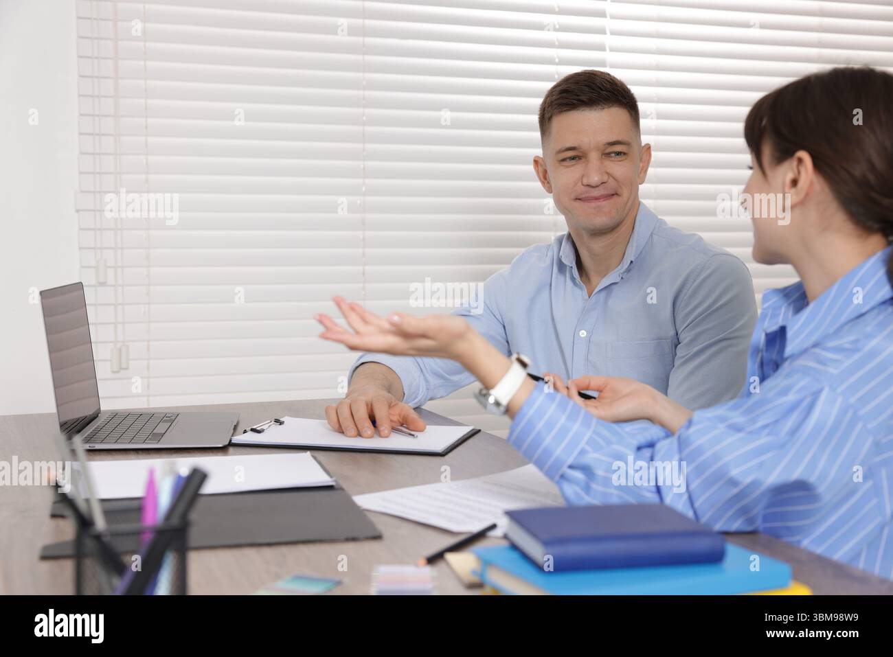 Consultant working with client at table in office. Business meeting ...