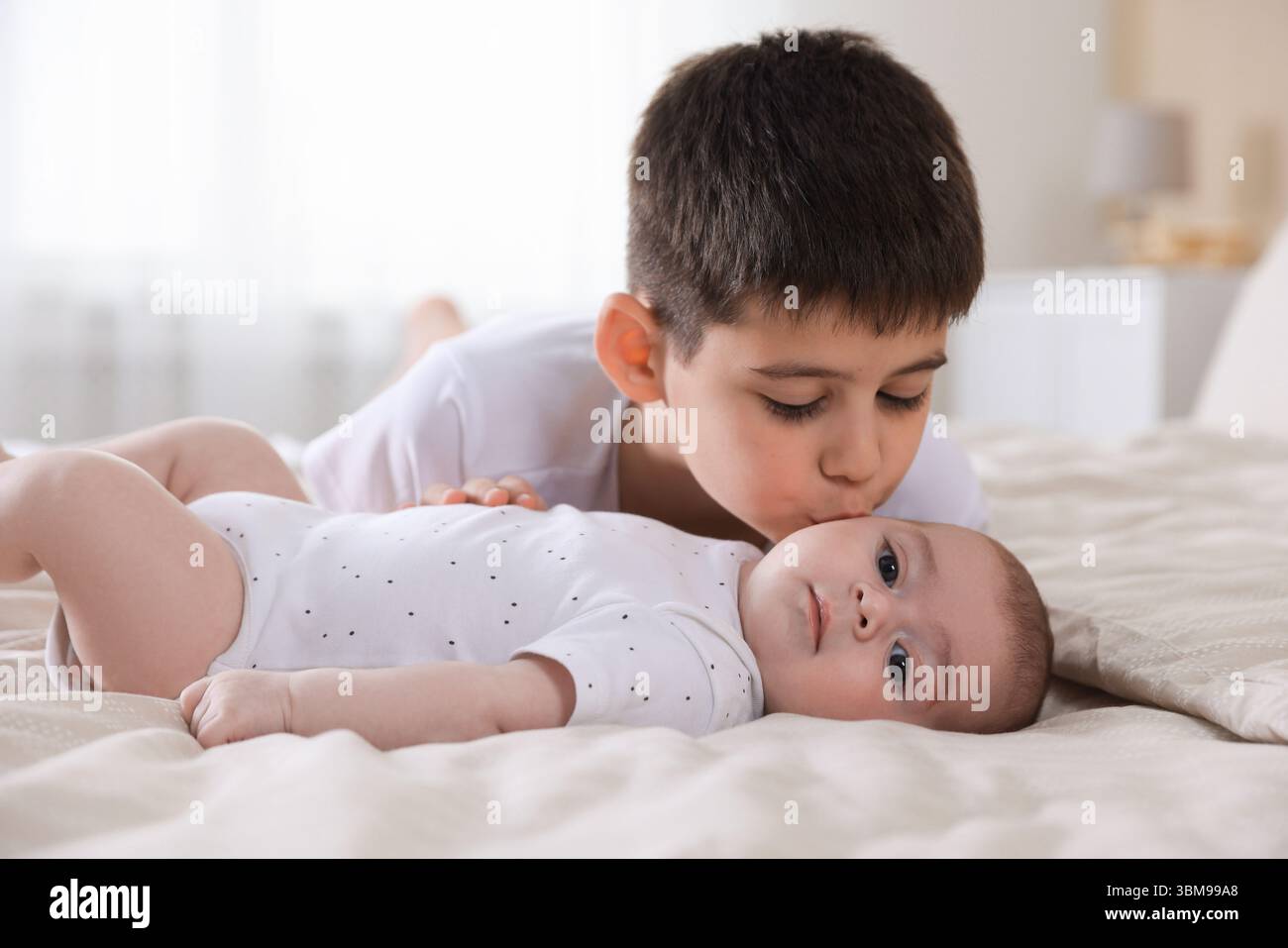 Cute little brothers on bed at home Stock Photo - Alamy