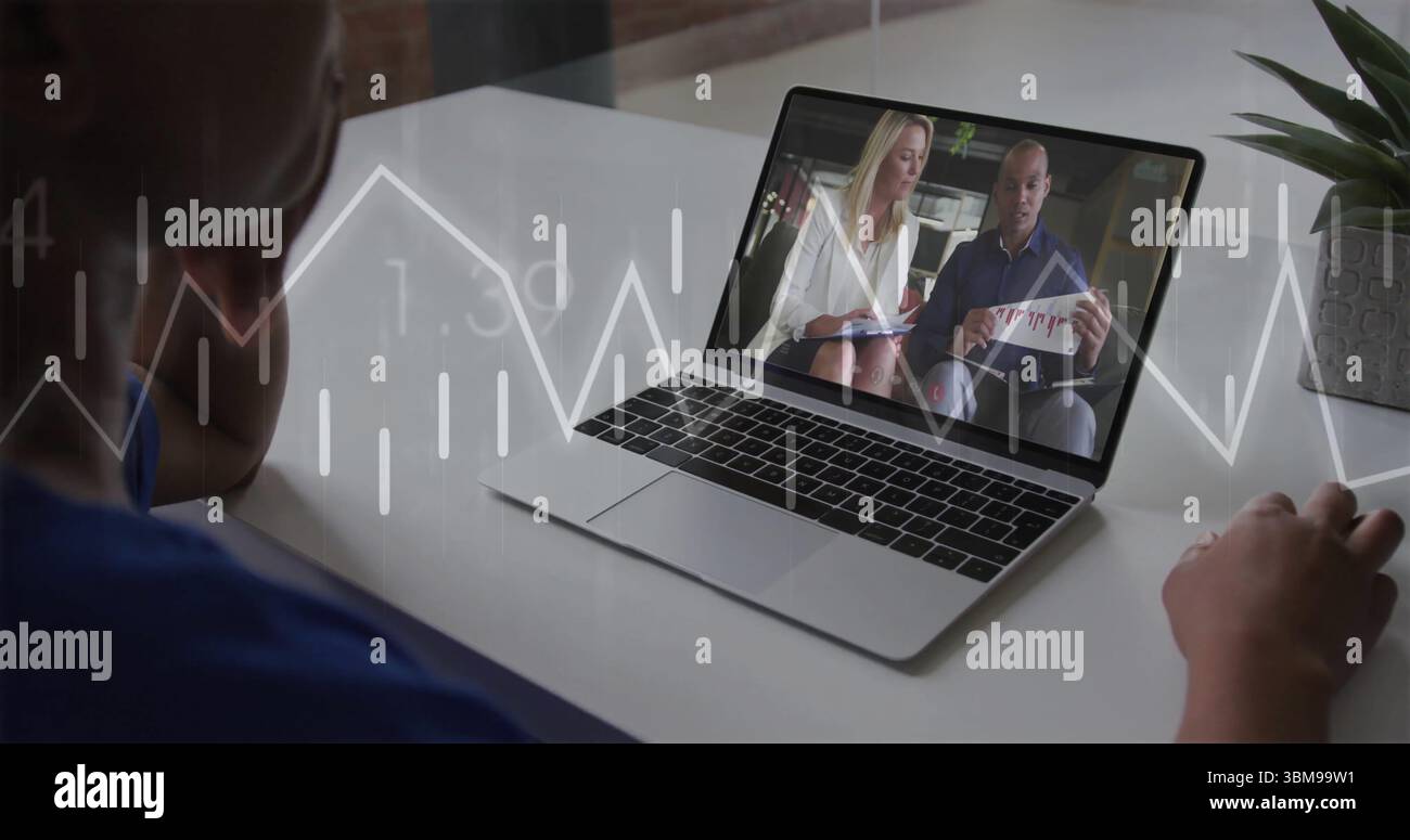 Showing laptop displaying colleagues reviewing charts and tablet in ...