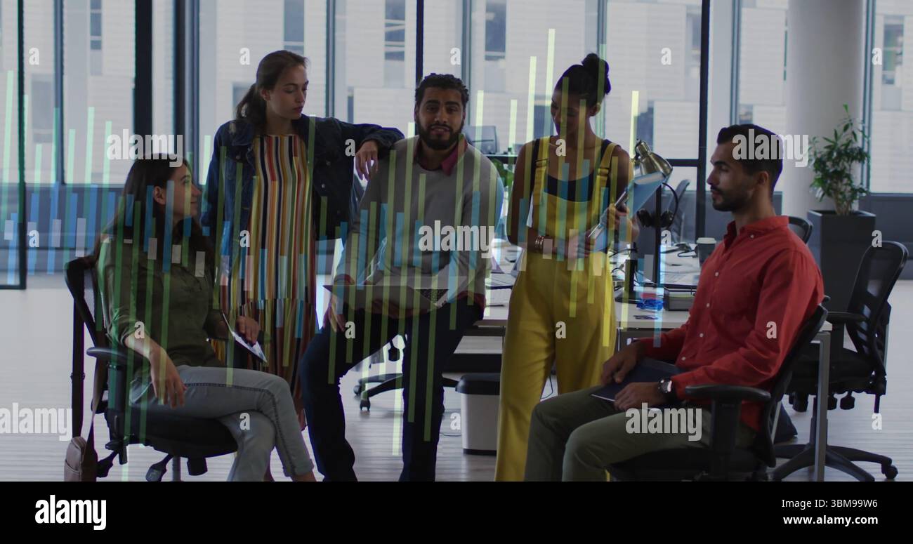Gathering office team discussing bar chart overlay in open-plan office ...