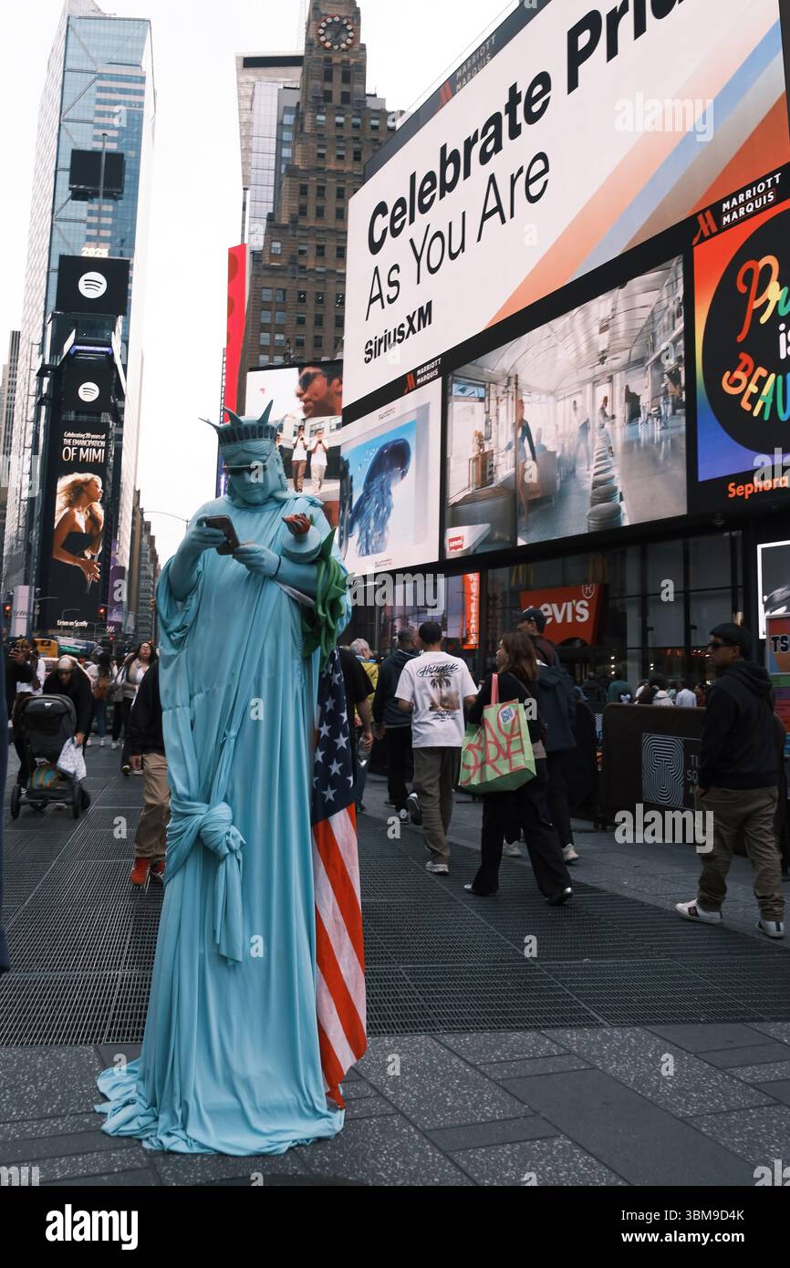 Street performer dressed as the Statue of Liberty, checking his ...
