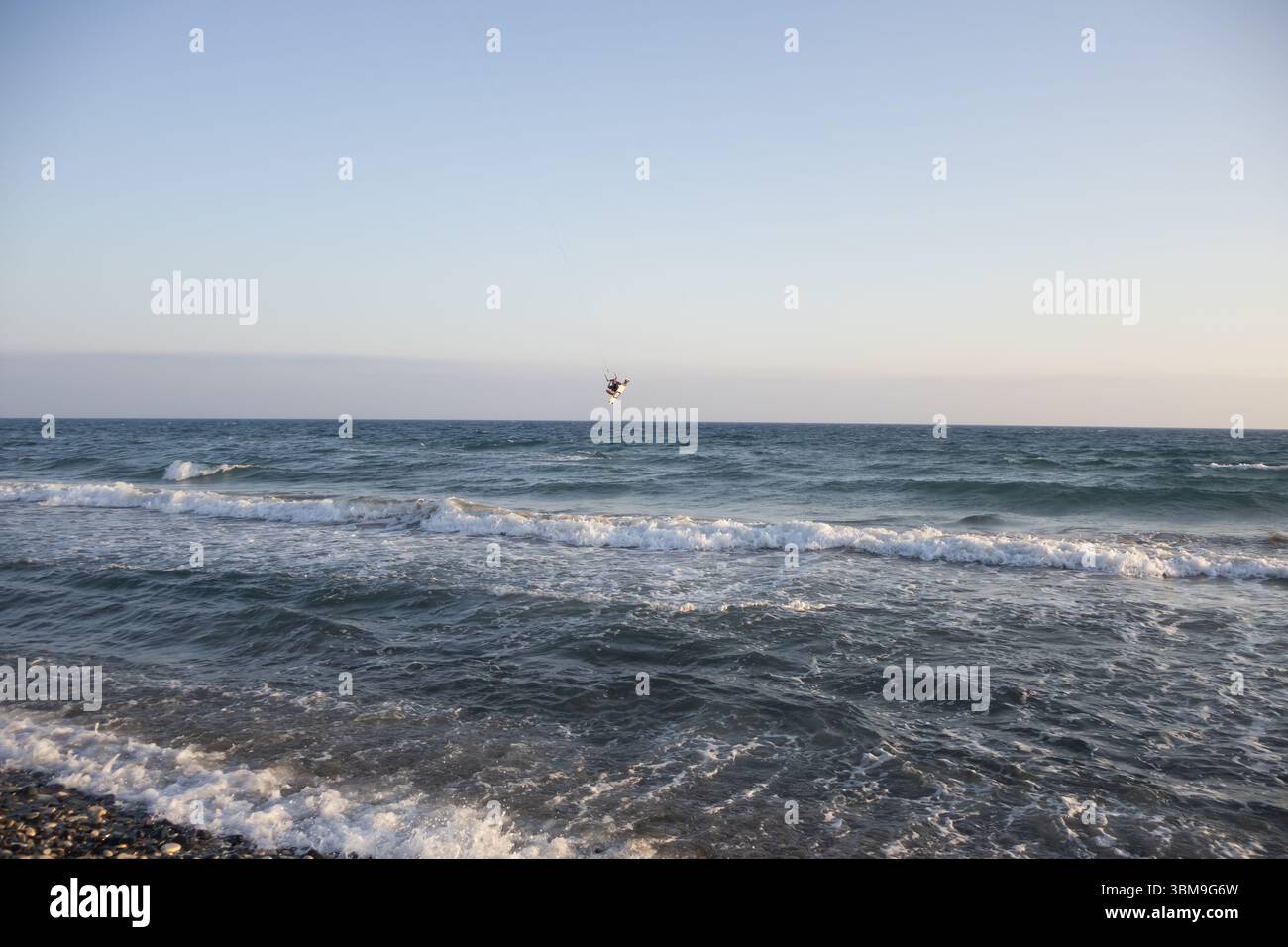 Limassol, Cyprus, 06-20-2025. A young man doing kite surfing on the ...