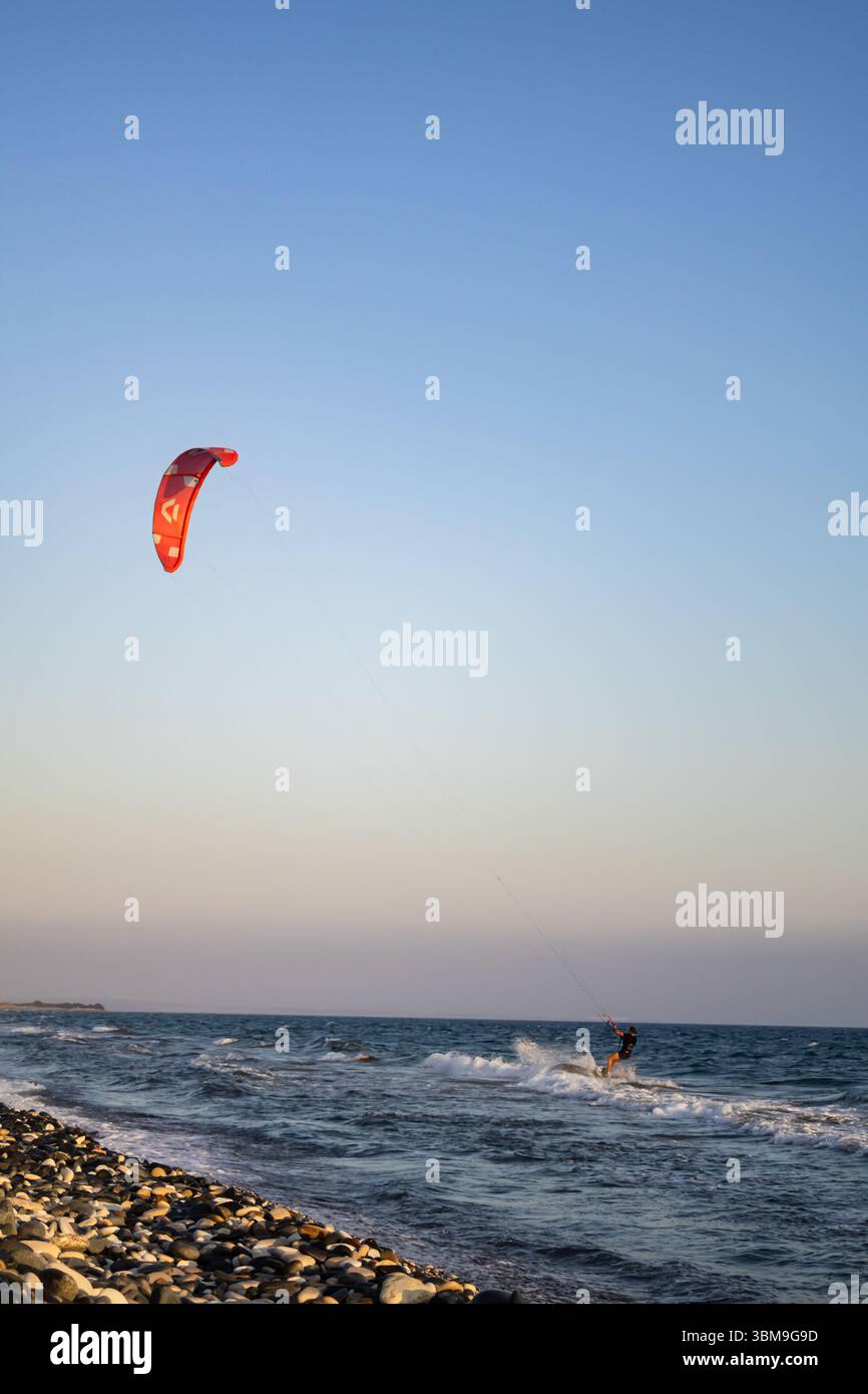 Limassol, Cyprus, 06-20-2025. A young man doing kite surfing on the ...