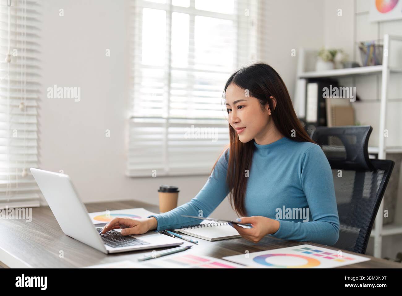 Design Innovation and Focused Application. A young woman engaged in ...