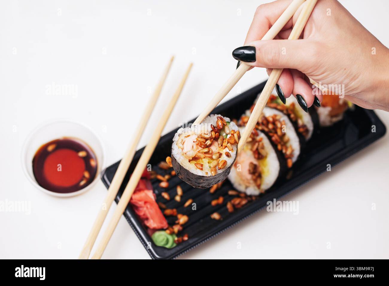 Elegant woman using chopsticks hi-res stock photography and images - Alamy
