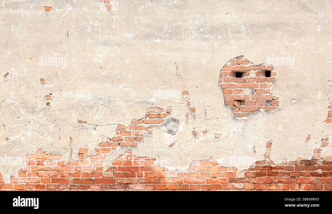 Weathered brick wall with crumbling plaster, creating a textured ...