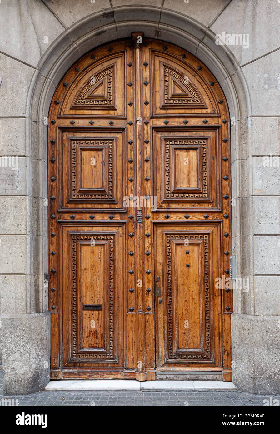 Classic wooden double door featuring a greek key pattern, exuding ...