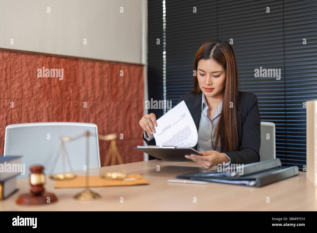 Document Review and Legal Insight. A lawyer analyzing legal documents ...