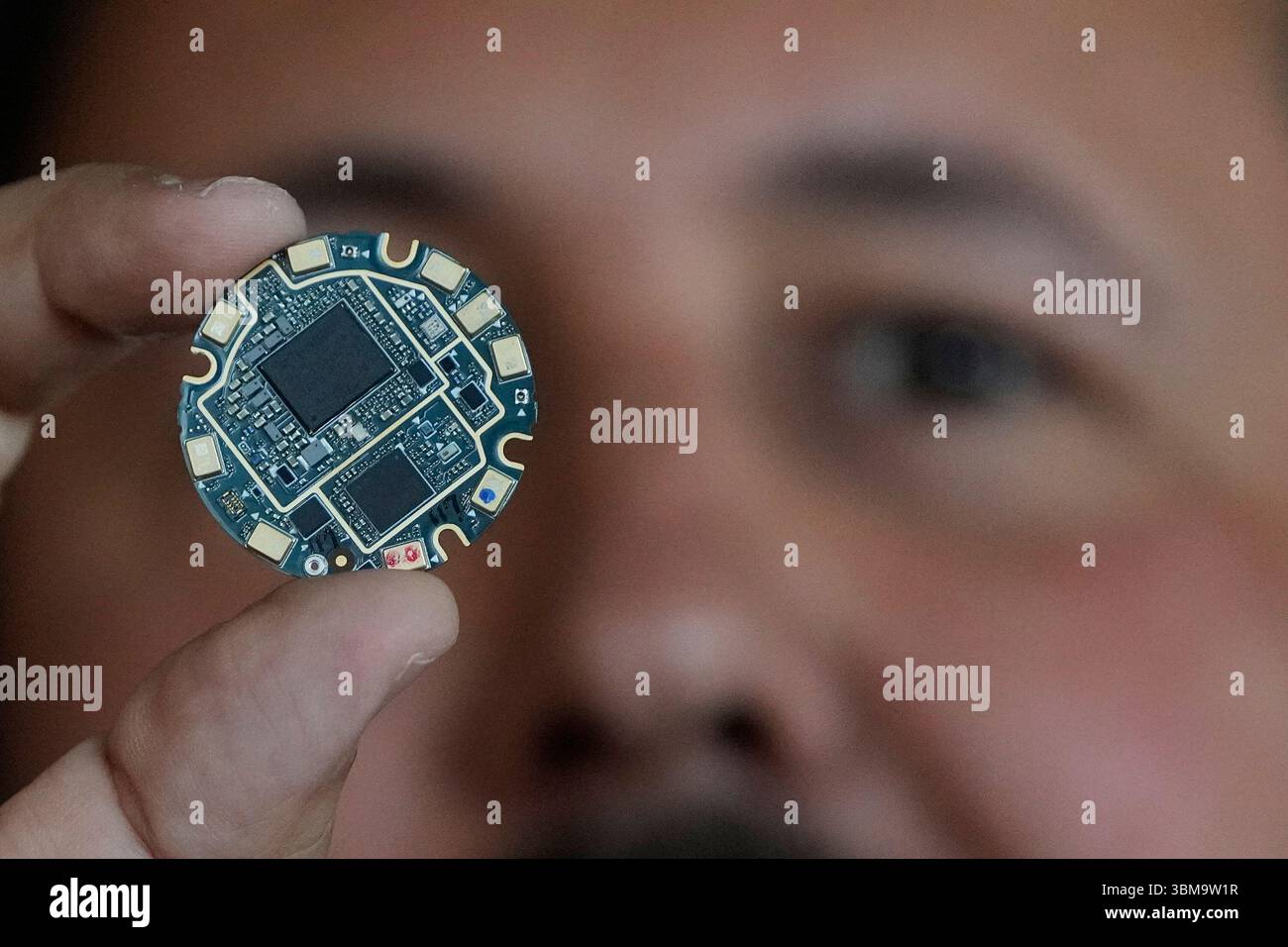 Jason Rugolo, founder and CEO of iyO, shows the motherboard of the iyO ...
