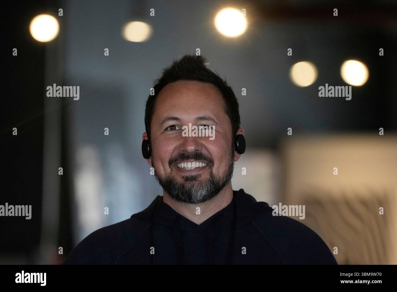 Jason Rugolo, founder and CEO of iyO, wears the iyO One audio computer ...