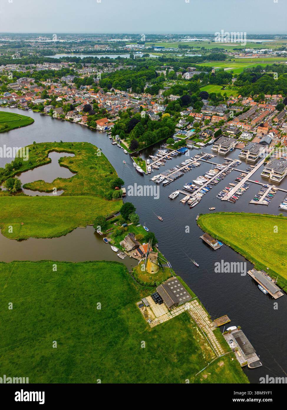 A top-down view of a marina with multiple boats docked along wooden ...
