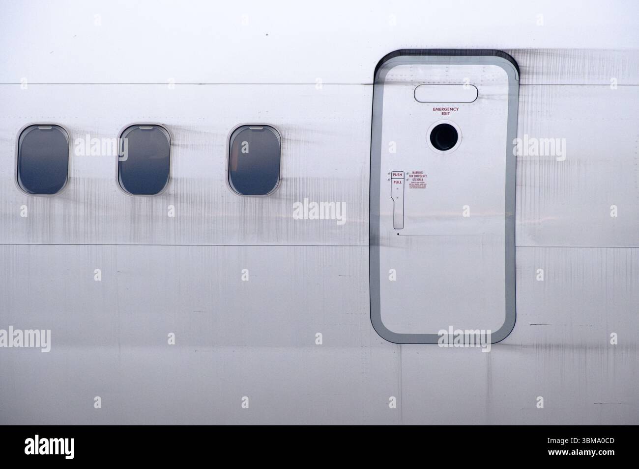 Close-up of a Boeing 737 MAX emergency exit door and passenger windows ...