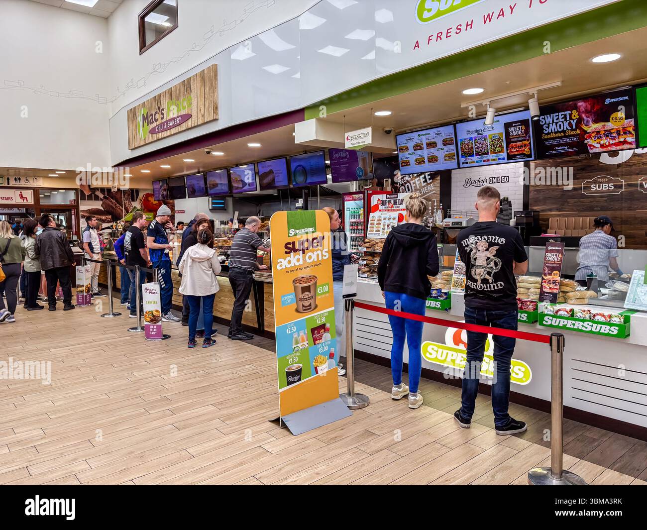 Barack Obama Plaza, Ireland. People queuing for food service inside a ...
