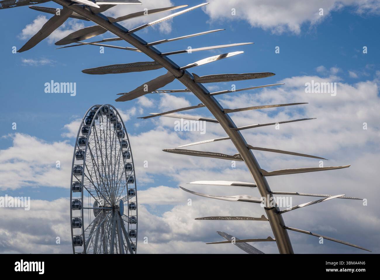View from the pedestrian bridge of a steel archway sculpture resembling ...