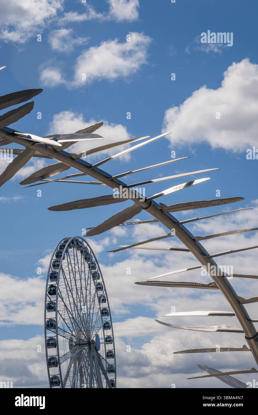 View from the pedestrian bridge of a steel archway sculpture resembling ...