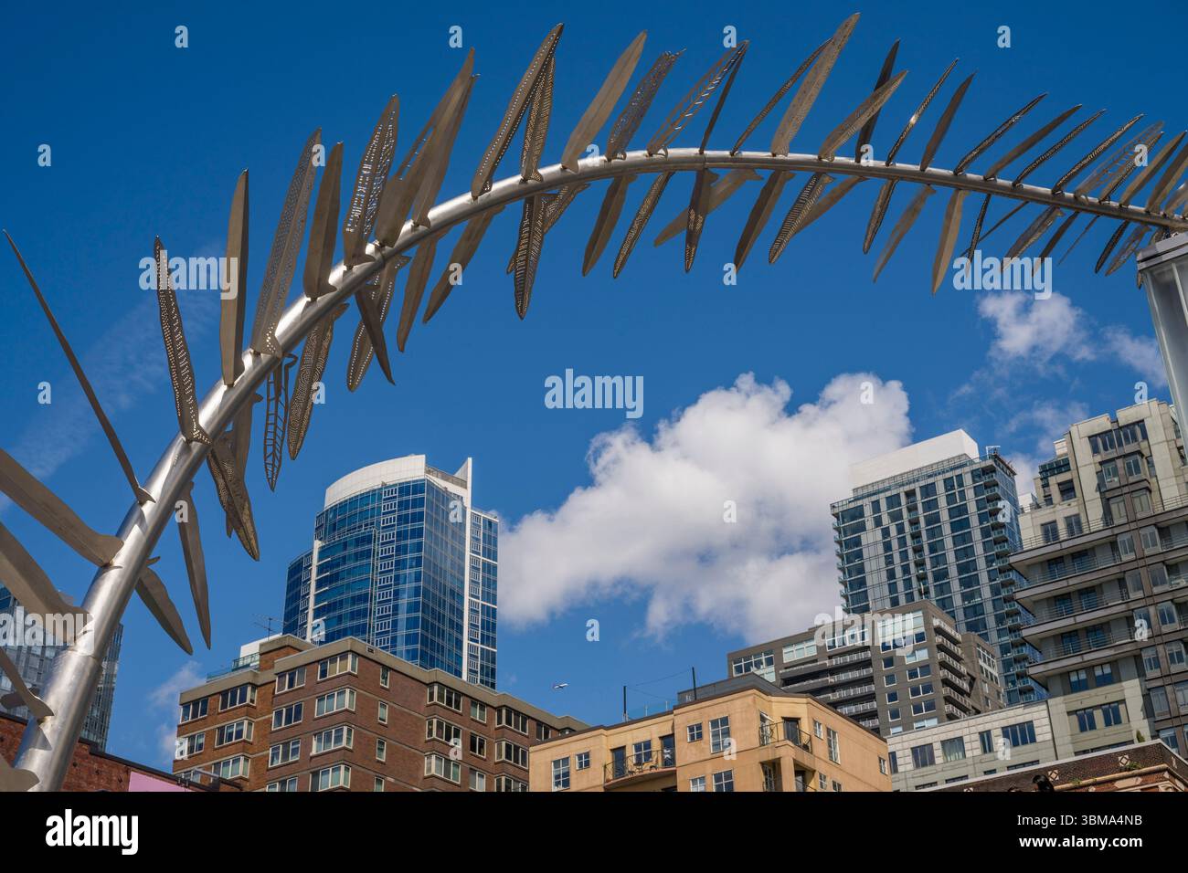 View from the pedestrian bridge to the waterfront of a steel archway ...