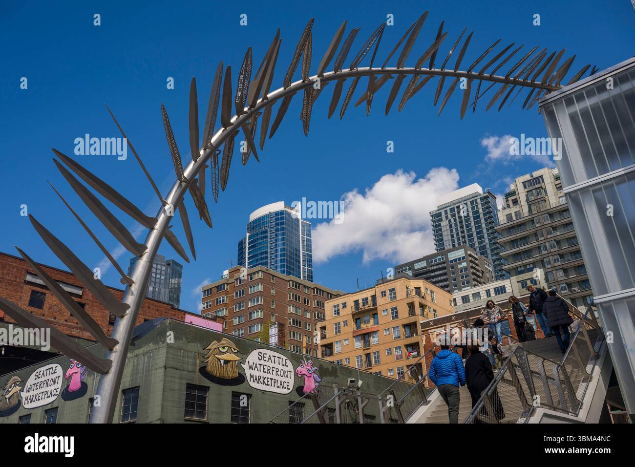 View from the pedestrian bridge to the waterfront of a steel archway ...