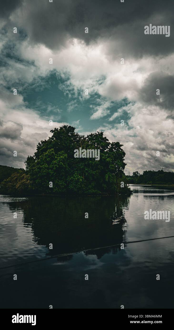 “Dramatic landscape of a small island covered with lush green trees ...