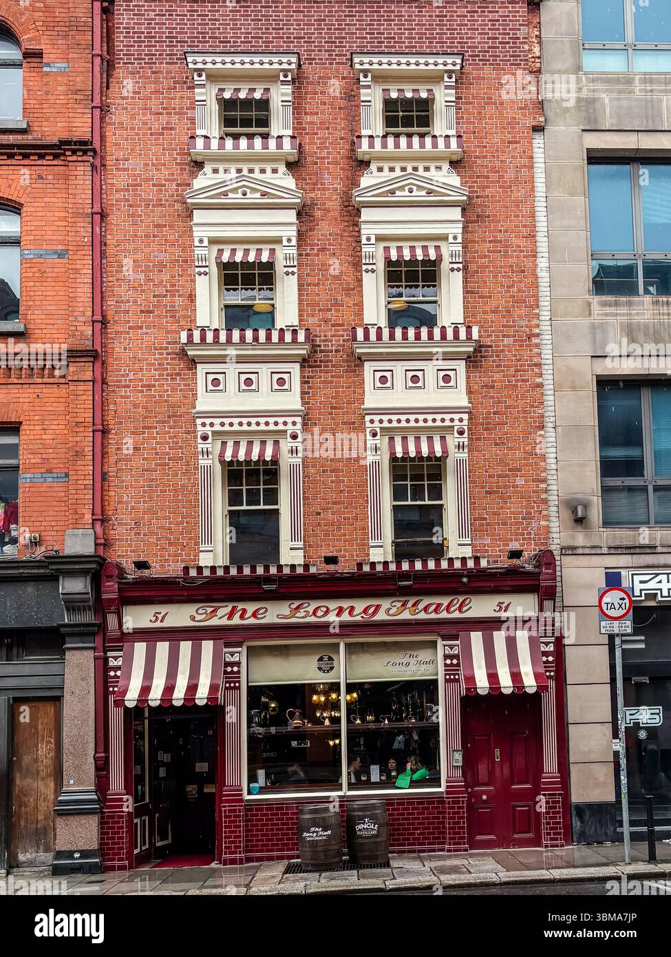 The Long Hall, a famous historic pub in Dublin, Ireland. Red brick ...