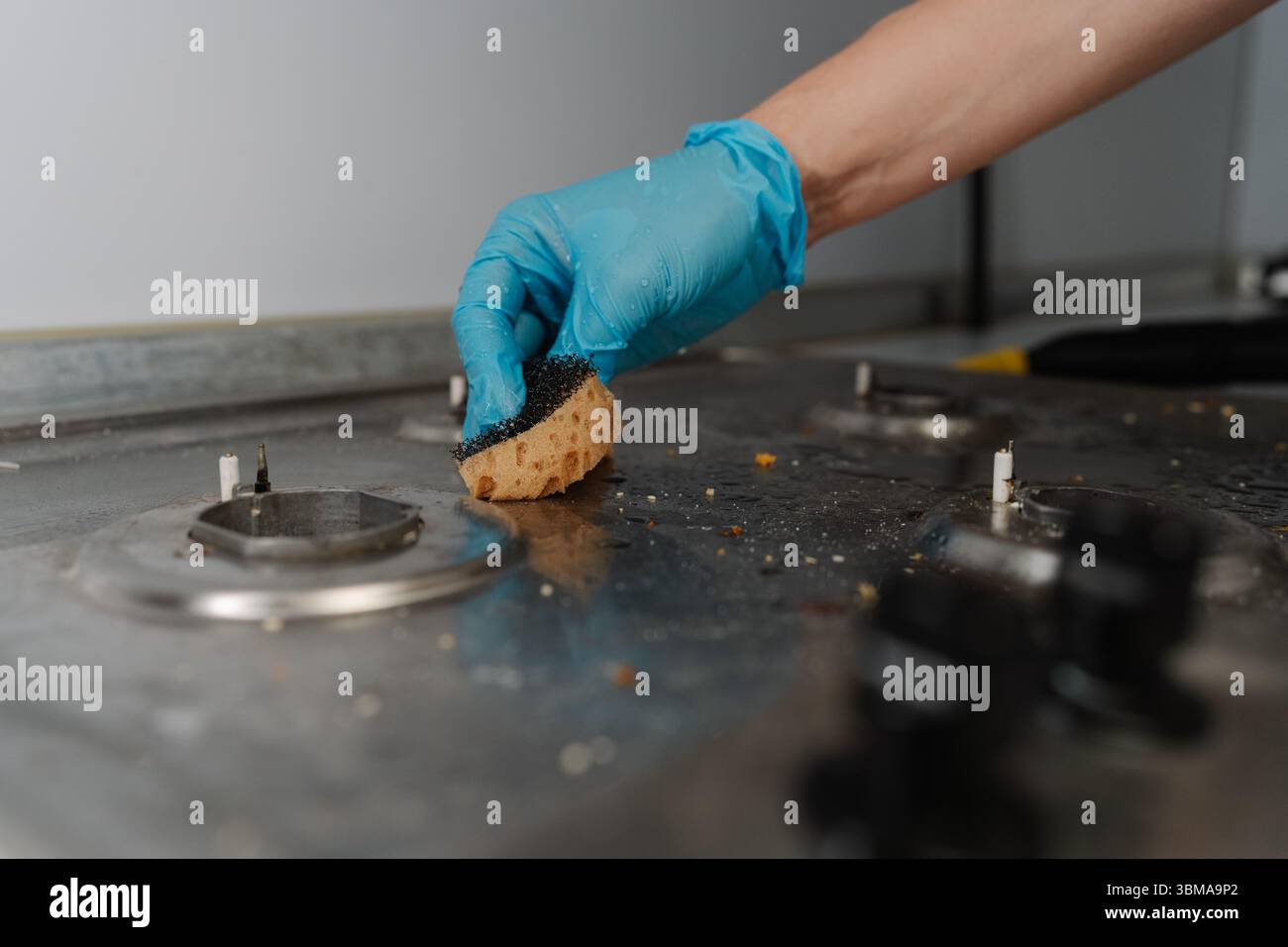 Close-up cropped shot of unrecognizable man wearing gloves scrubbing ...