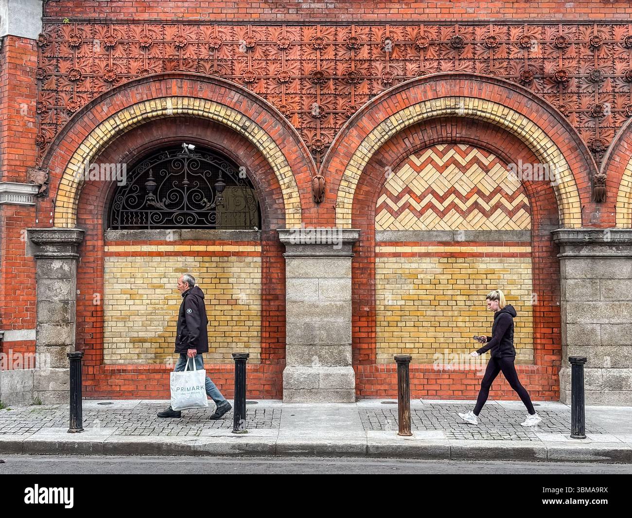 Detailed brick building facade with decorative terracotta and arches ...