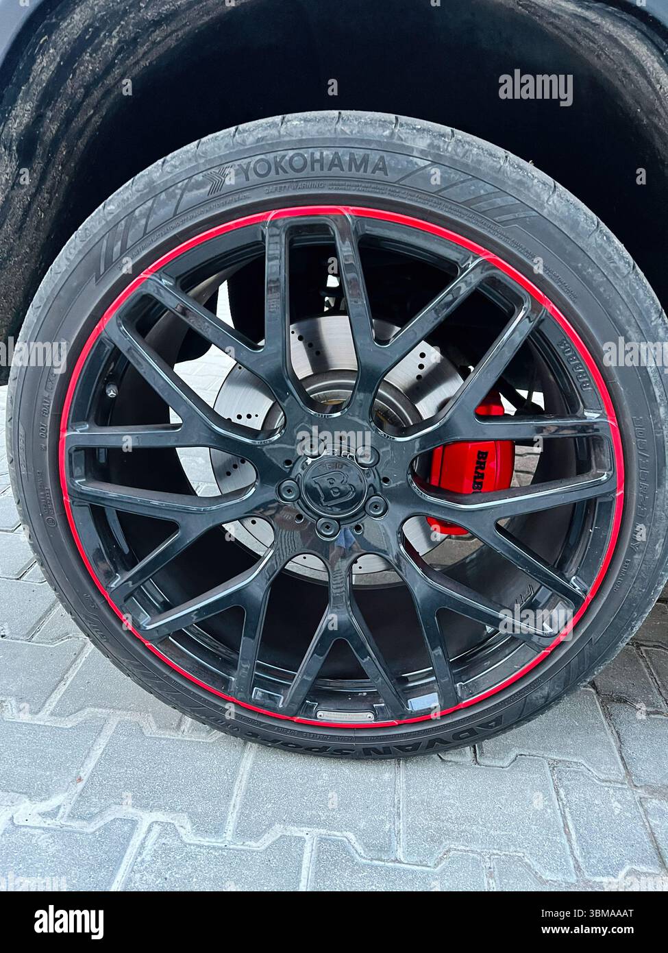 Kyiv, Ukraine - June 24, 2025: Car tire featuring black alloy rim with ...