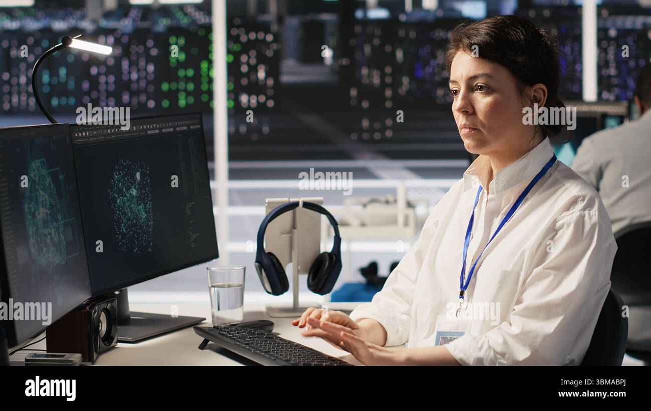 Data center technician monitors server rigs performing AI training and inference tasks. Server ...