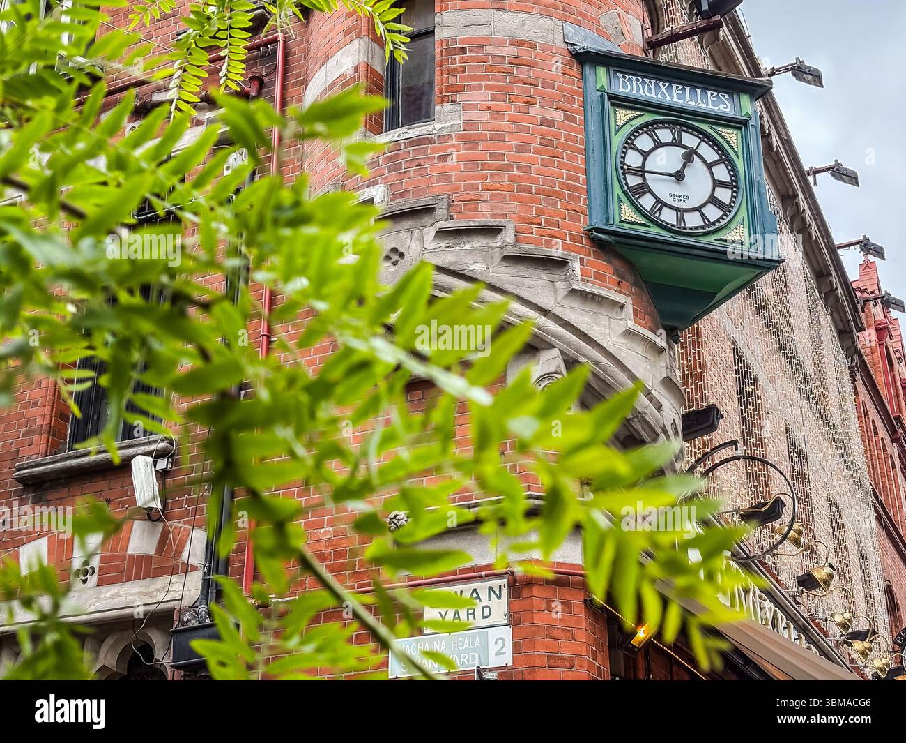 Bruxelles clock on a historic red brick building corner in Dublin ...