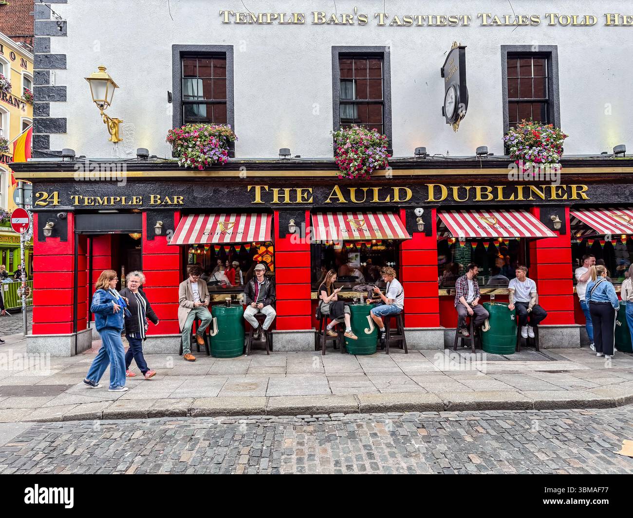 The Auld Dubliner pub facade with red and white striped awnings and ...