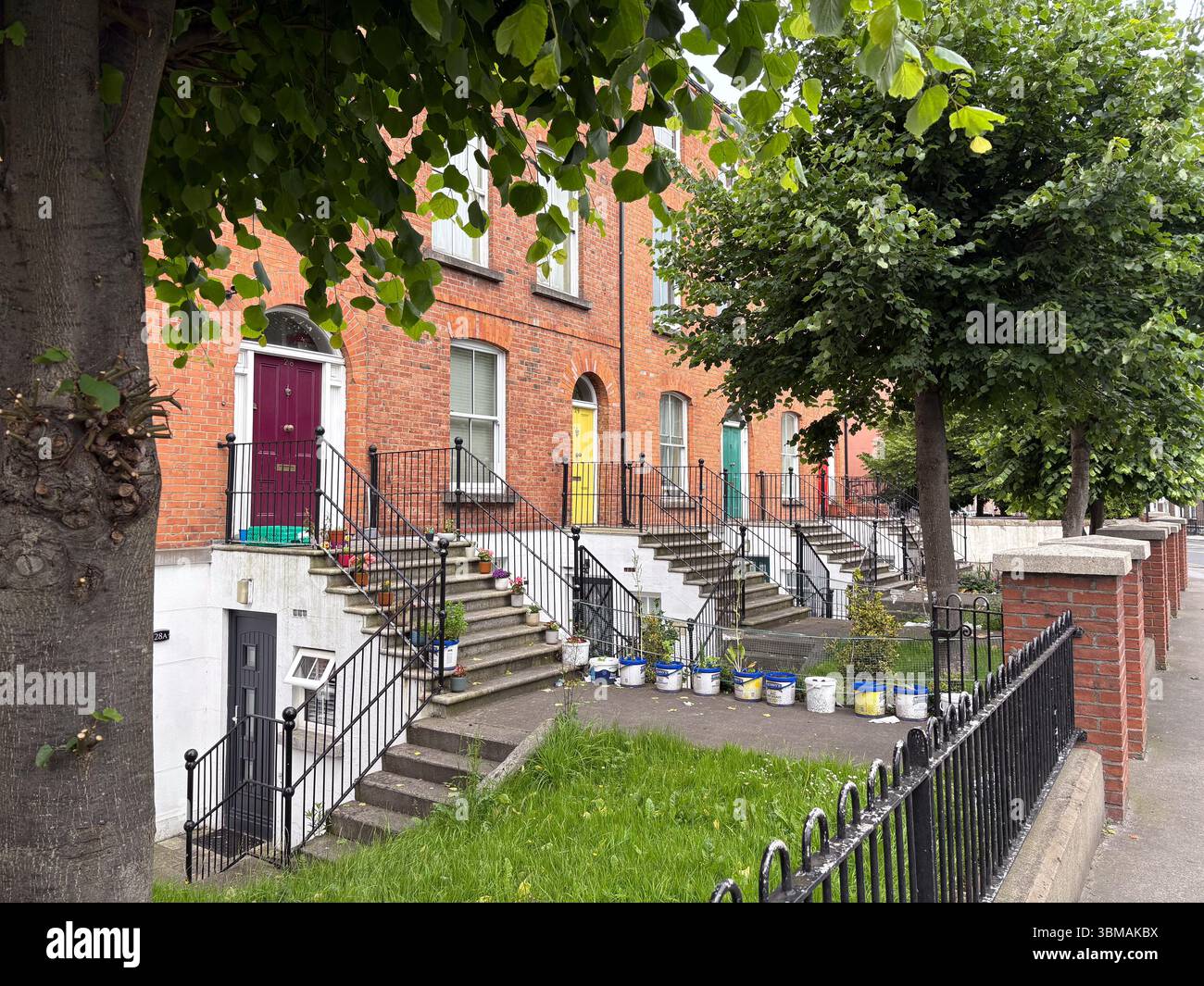 Terraced brick houses with steps and colorful doors in Dublin, Ireland ...