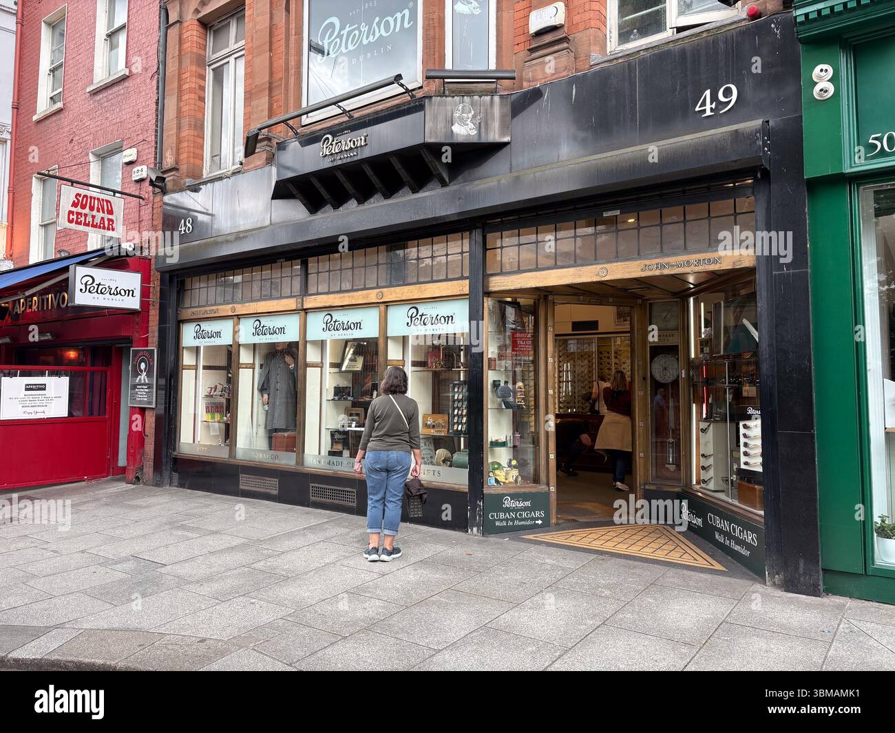Peterson of Dublin. Retail store facade with a woman standing outside ...