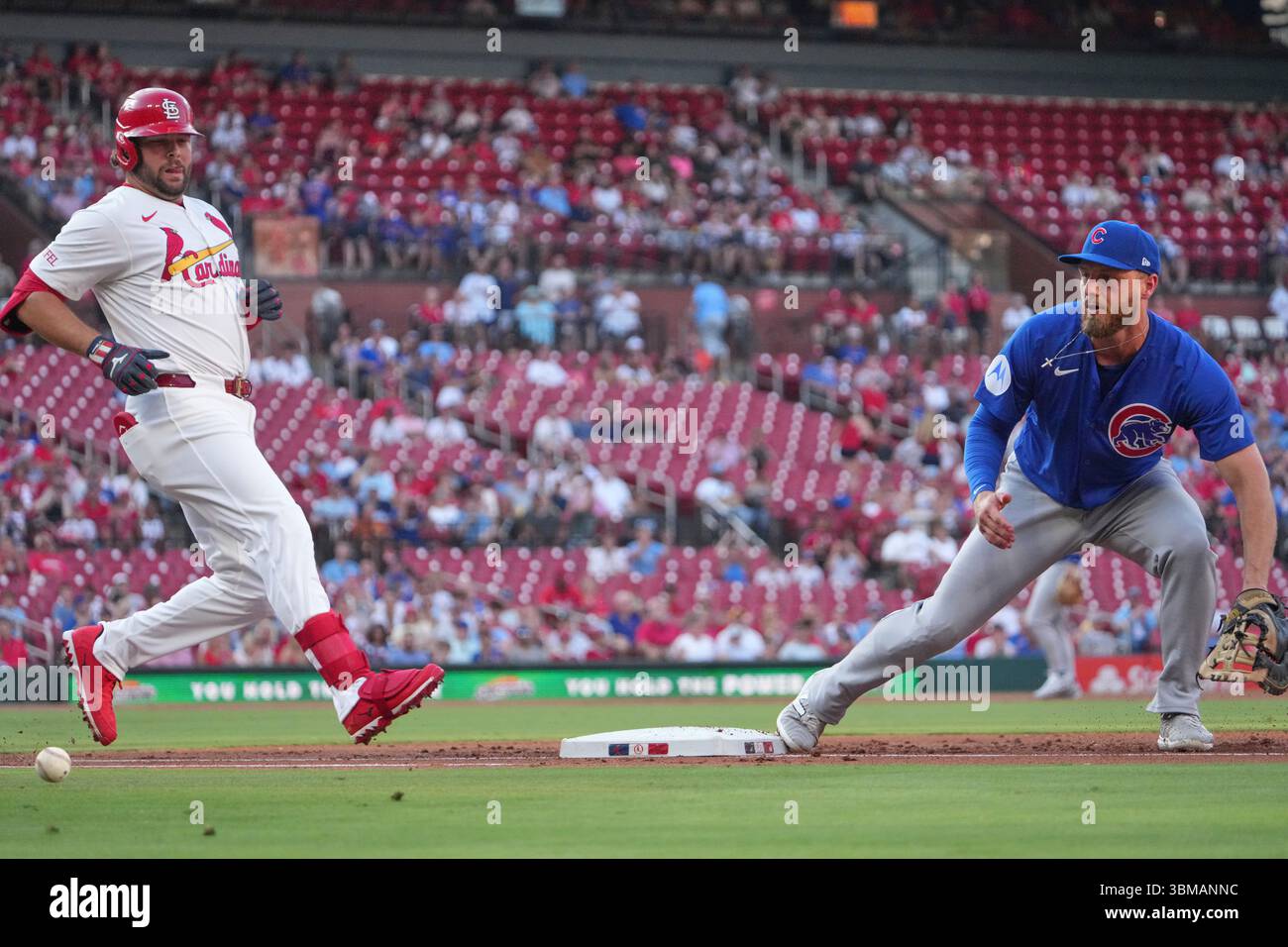 St. Louis Cardinals' Alec Burleson, left, reaches on a missed catch ...