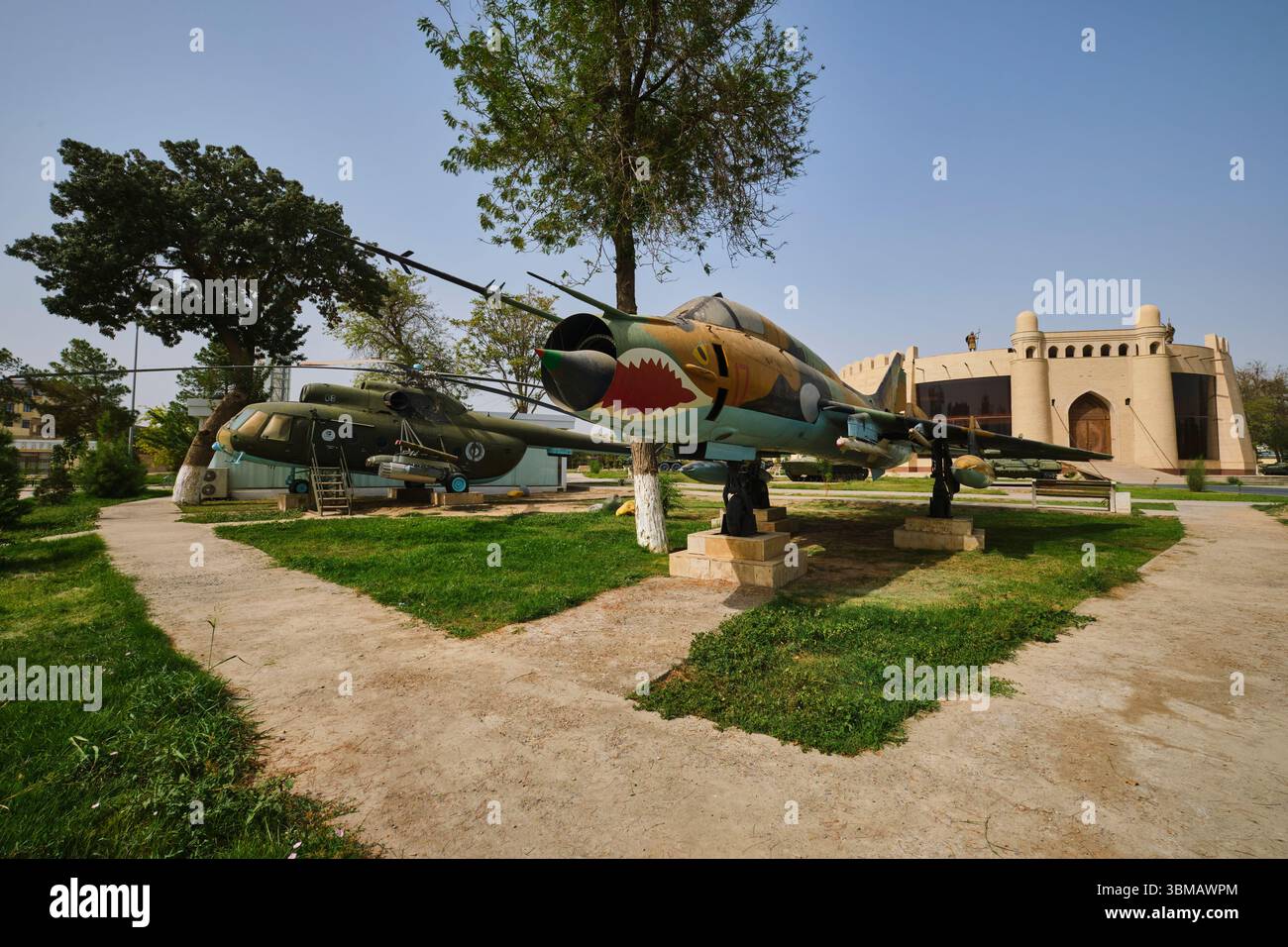An old military fighter jet, with mean mouth painting on the front. On ...