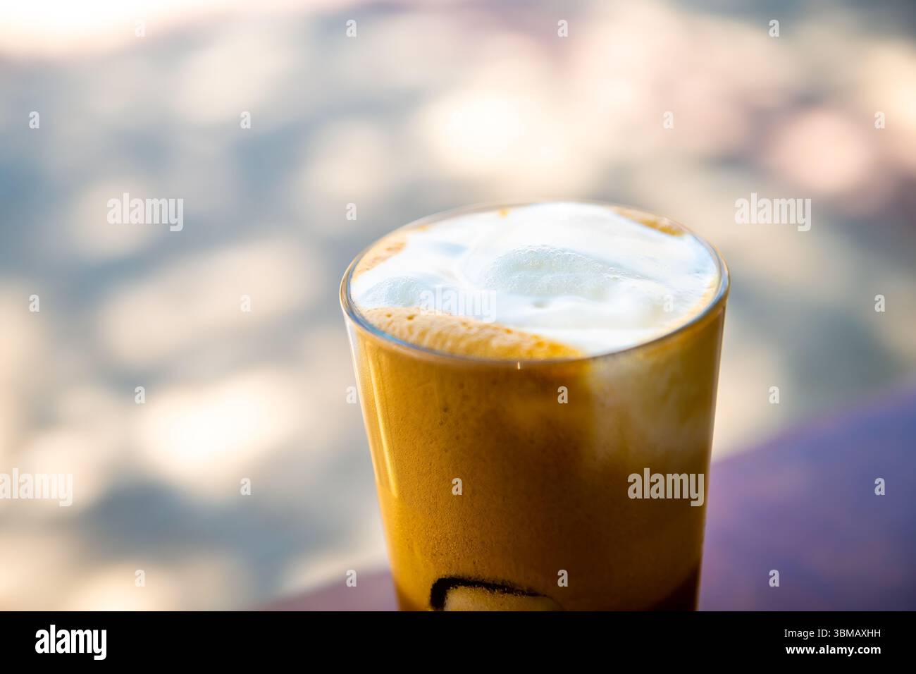 Freddo cappuccino espresso coffee drink beverage in glass macro of foam ...