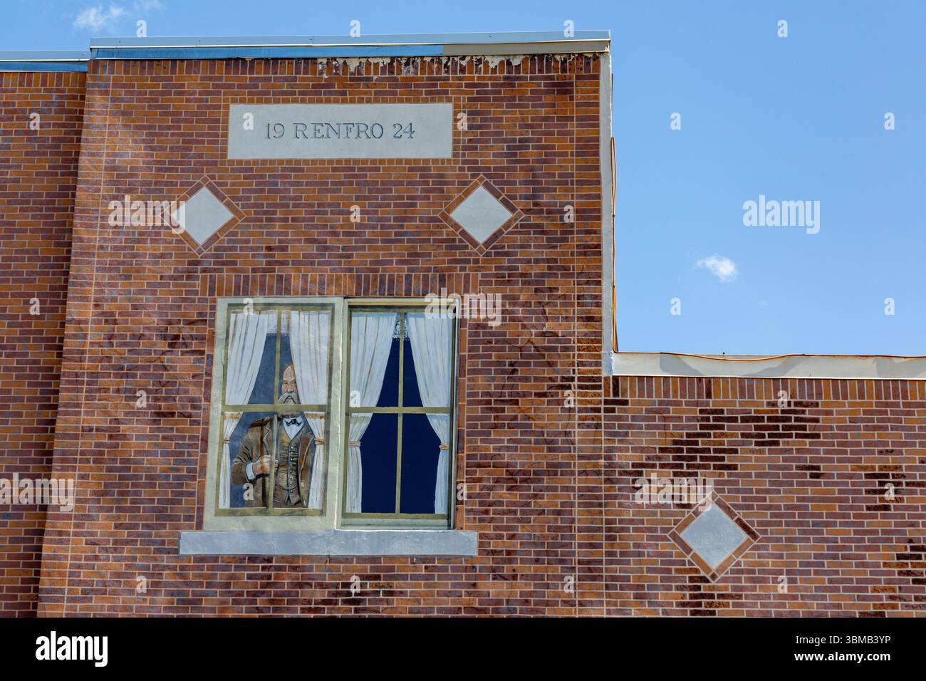 A figure depicts a man peering out of a window of the Renfro Building in downtown Cleburne ...